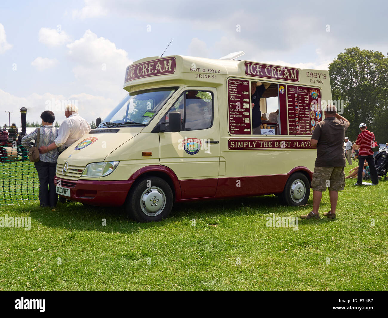 An ice cream van at a vintage fair in Hampshire with a customer looking ...