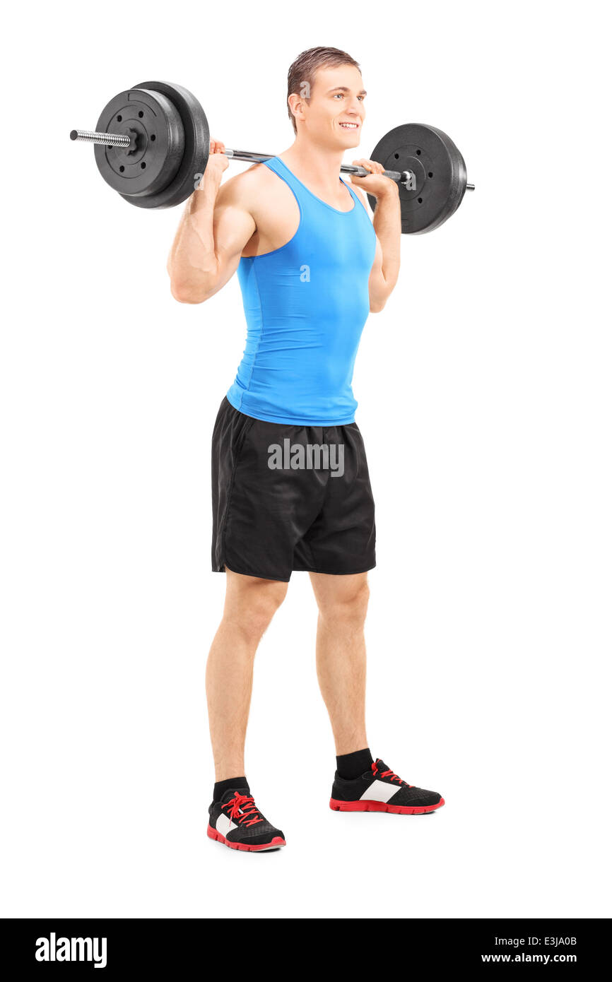 Full length portrait of a young man lifting a barbell Stock Photo - Alamy