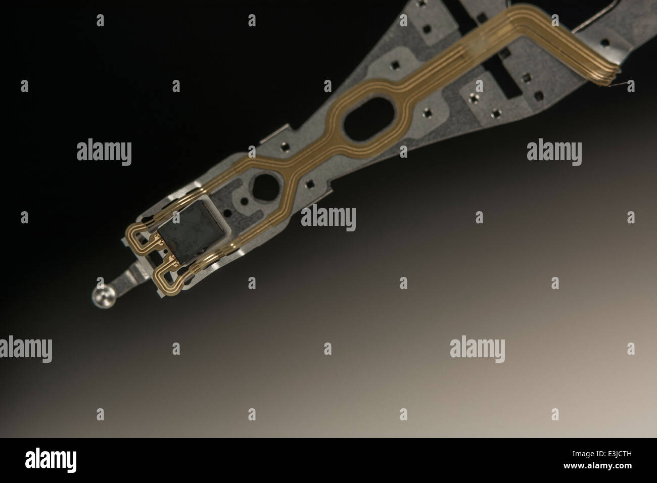 Macro-photo of HDD read-write head showing underside circuit wiring ...