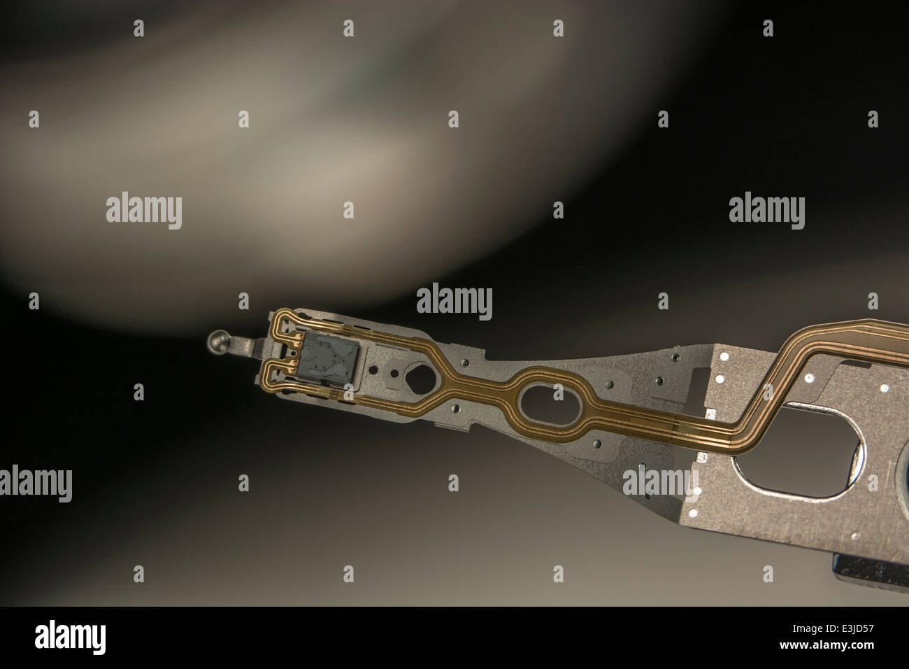 Macro-photo of HDD read-write head showing underside circuit wiring ...