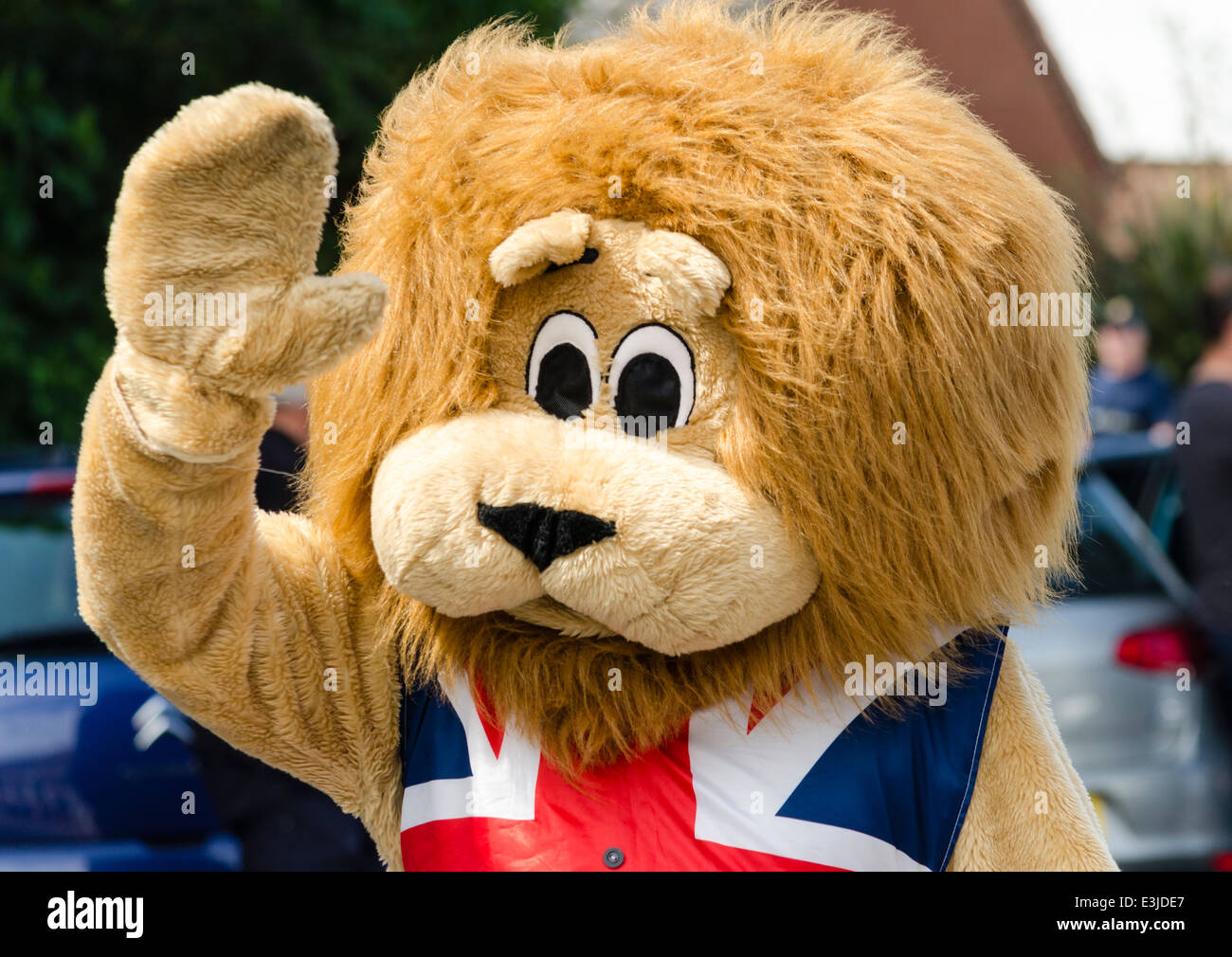 Man in a lion costume waving Stock Photo - Alamy