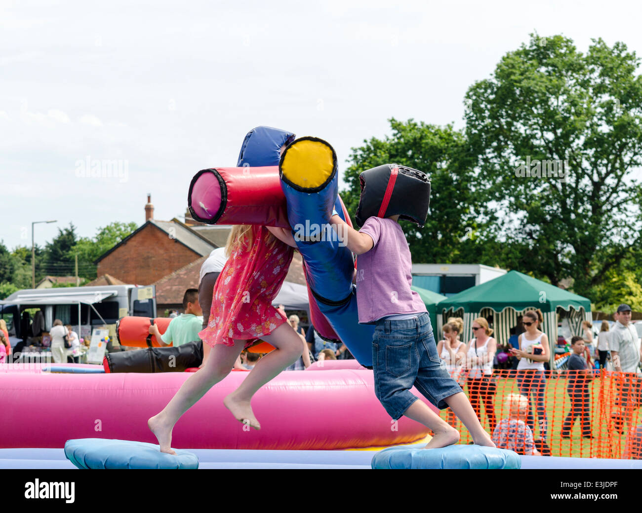 Children trying to knock each other of their podium Stock Photo - Alamy