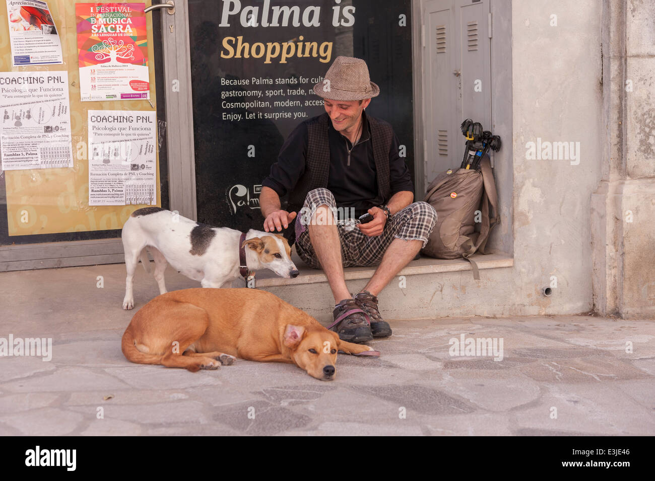 Man sat with his two dogs in a doorway, Majorca, Palma Stock Photo - Alamy