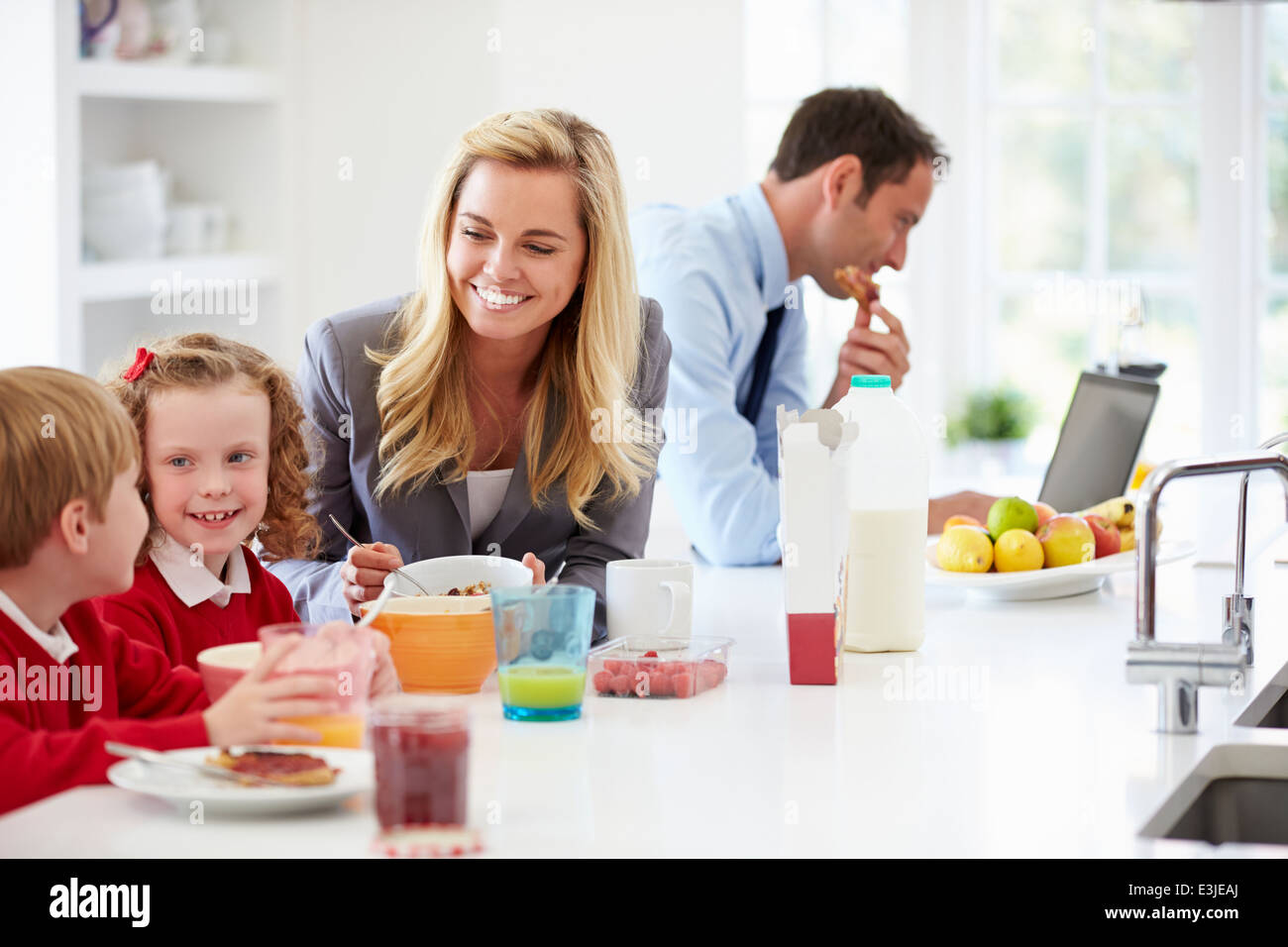Family Having Breakfast In Kitchen Before School And Work Stock Photo ...