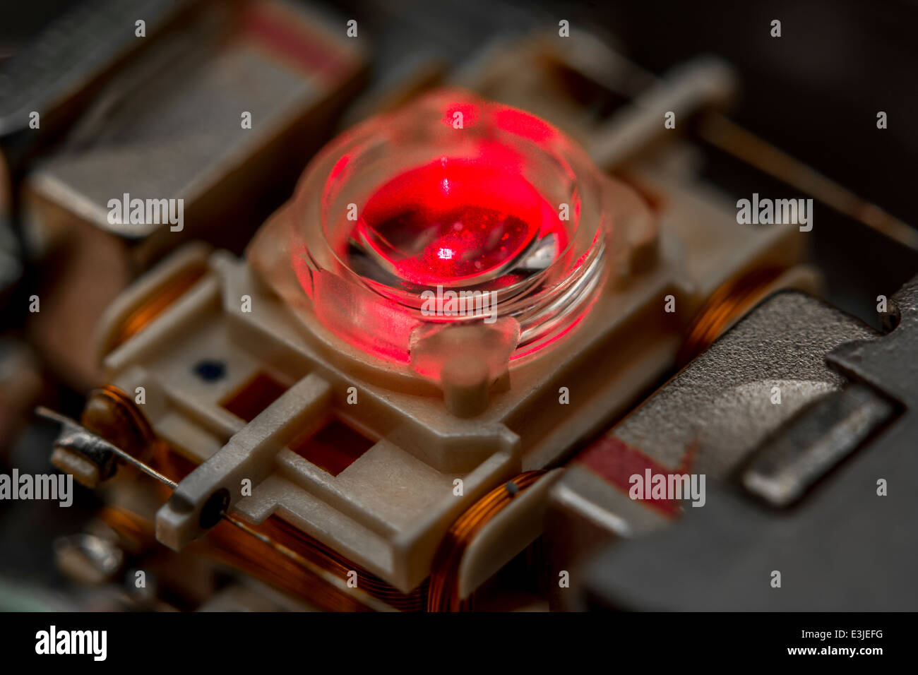 Macro-photo of CD-ROM laser assembly - lit internally with a red laser ...