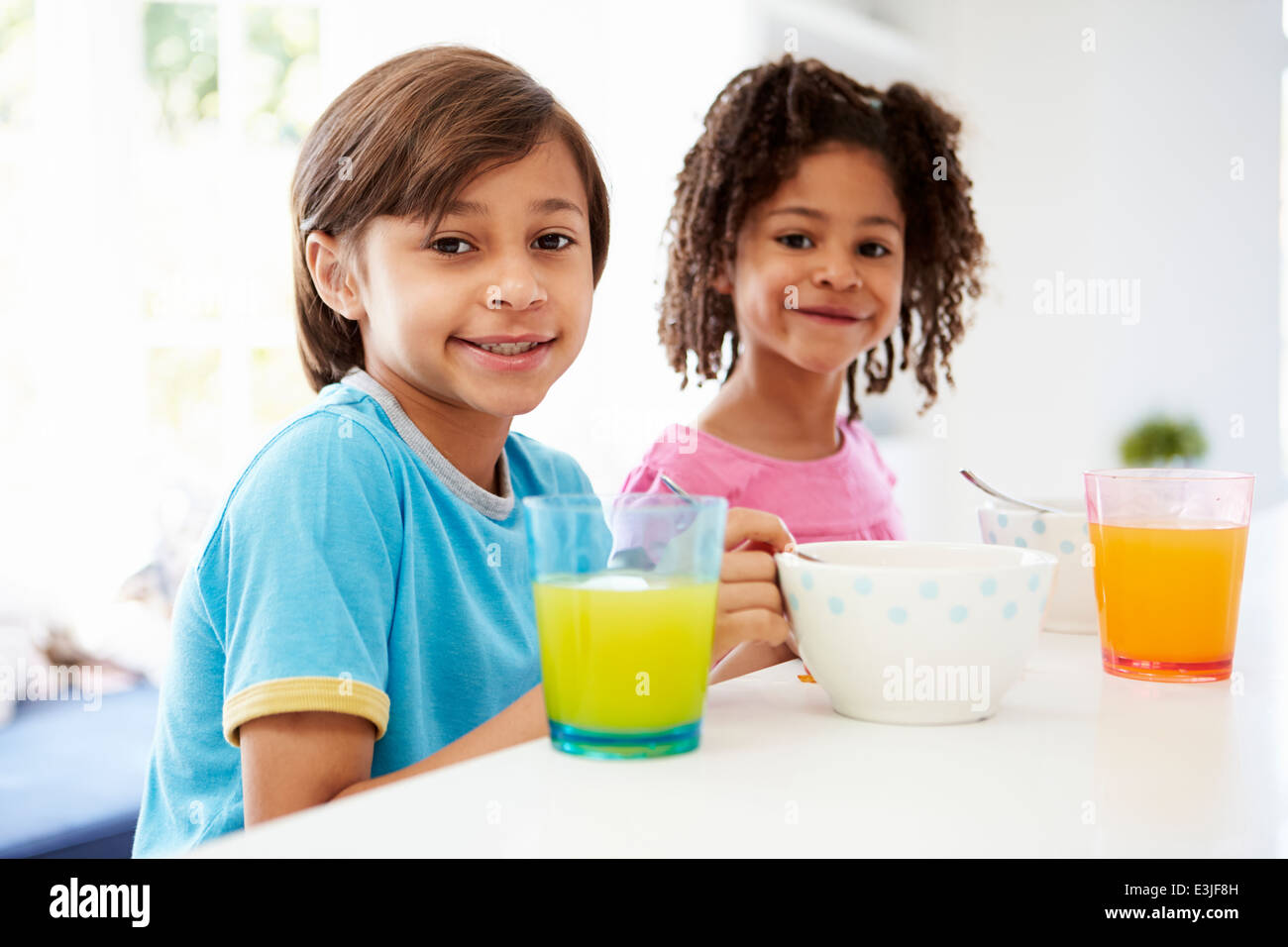Two Children Having Breakfast In Kitchen Together Stock Photo - Alamy