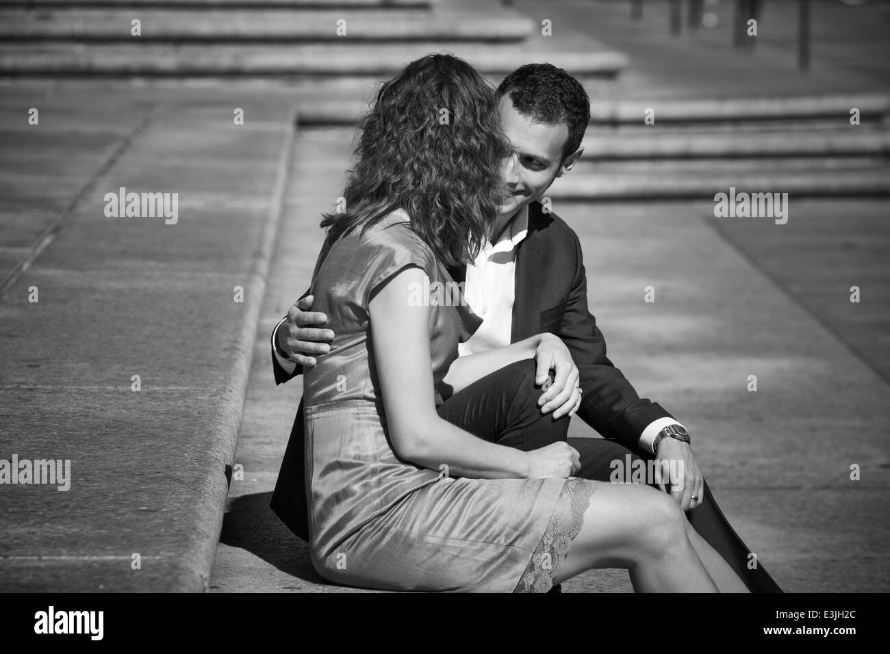 Two people sitting on stairs Black and White Stock Photos & Images - Alamy