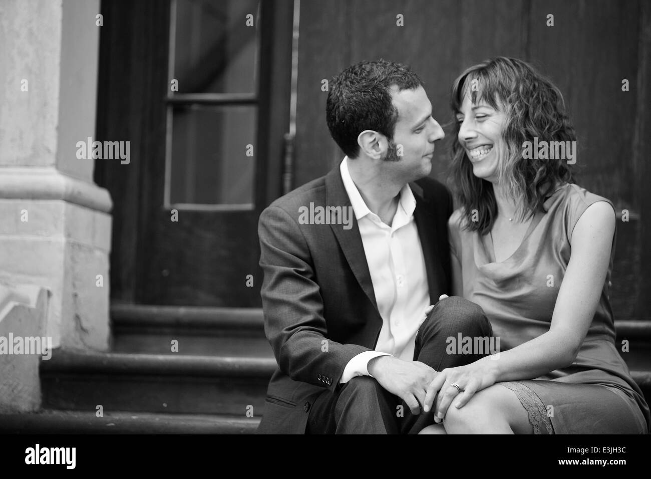Two people sitting on stairs Black and White Stock Photos & Images - Alamy