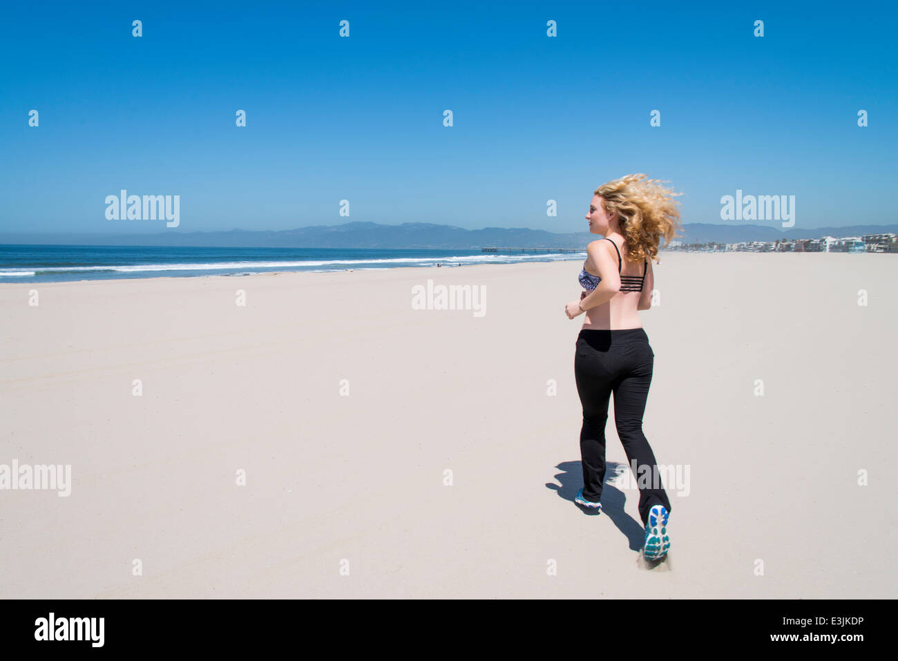 Young woman running beach hi-res stock photography and images - Alamy