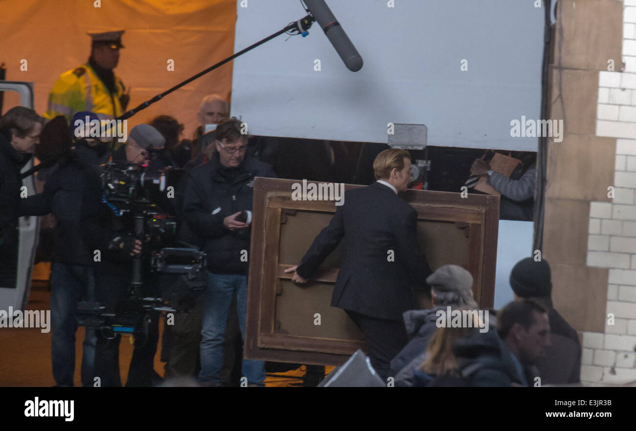 Johnny Depp on the set of his new movie 'Mortdecai' in London. The actor seen carrying a large ...