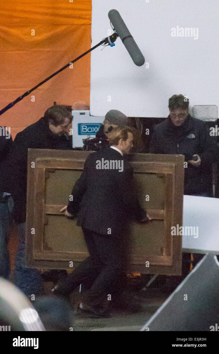 Johnny Depp on the set of his new movie 'Mortdecai' in London. The actor seen carrying a large ...