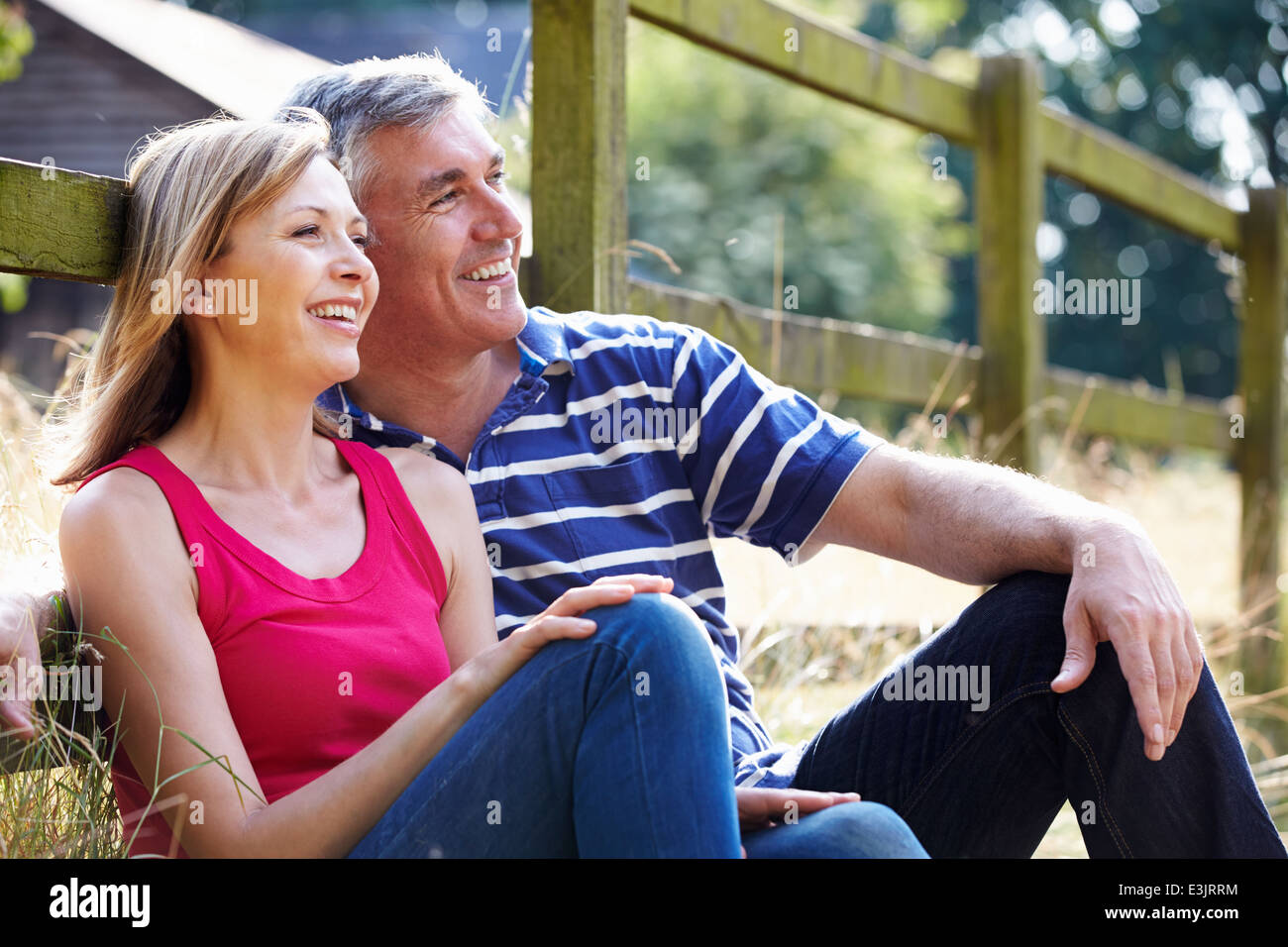 Romantic Middle Aged Couple Relaxing On Walk In Countryside Stock Photo ...