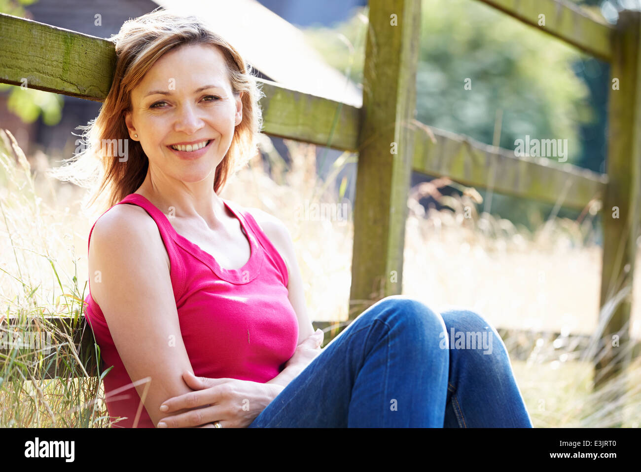 Attractive Woman Relaxing On Walk In Countryside Stock Photo - Alamy
