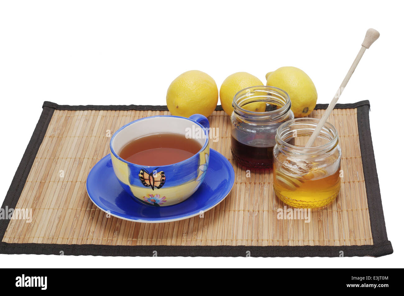 tea with lemon and honey in cup on mat Stock Photo - Alamy