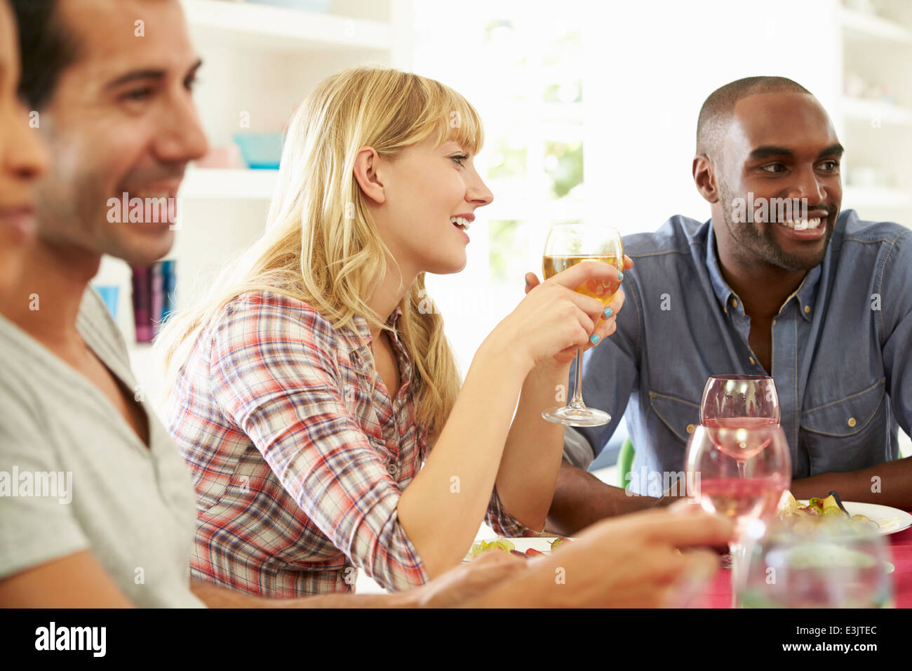 Group Of Friends Sitting Around Table Having Dinner Party Stock Photo ...