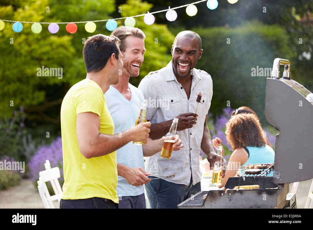 Group Of Men Cooking On Barbeque At Home Stock Photo - Alamy