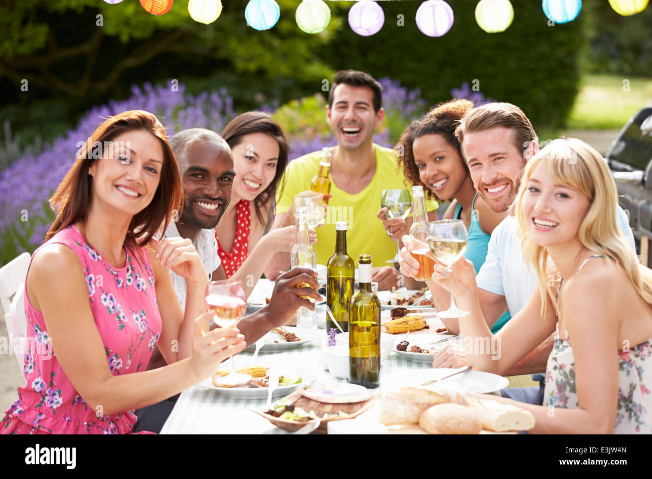 Group Of Friends Having Outdoor Barbeque At Home Stock Photo - Alamy