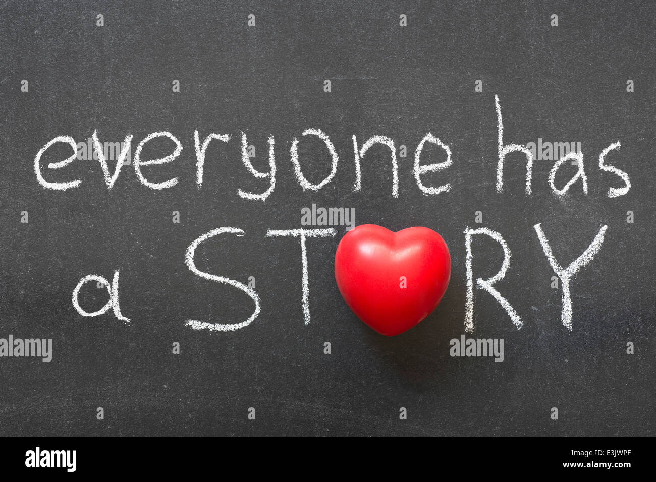 everyone has a story phrase handwritten on chalkboard with heart symbol ...
