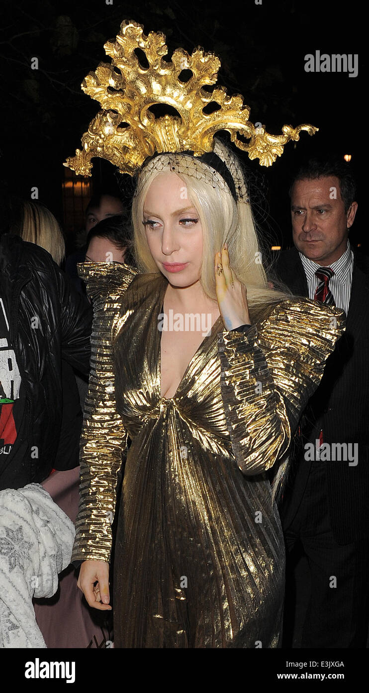 Lady Gaga returns to her hotel, wearing a gold dress with matching gold ...