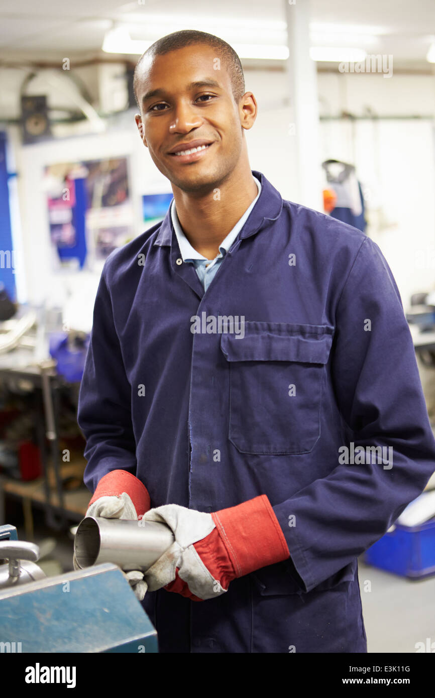 Apprentice Engineer Working On Factory Floor Stock Photo - Alamy