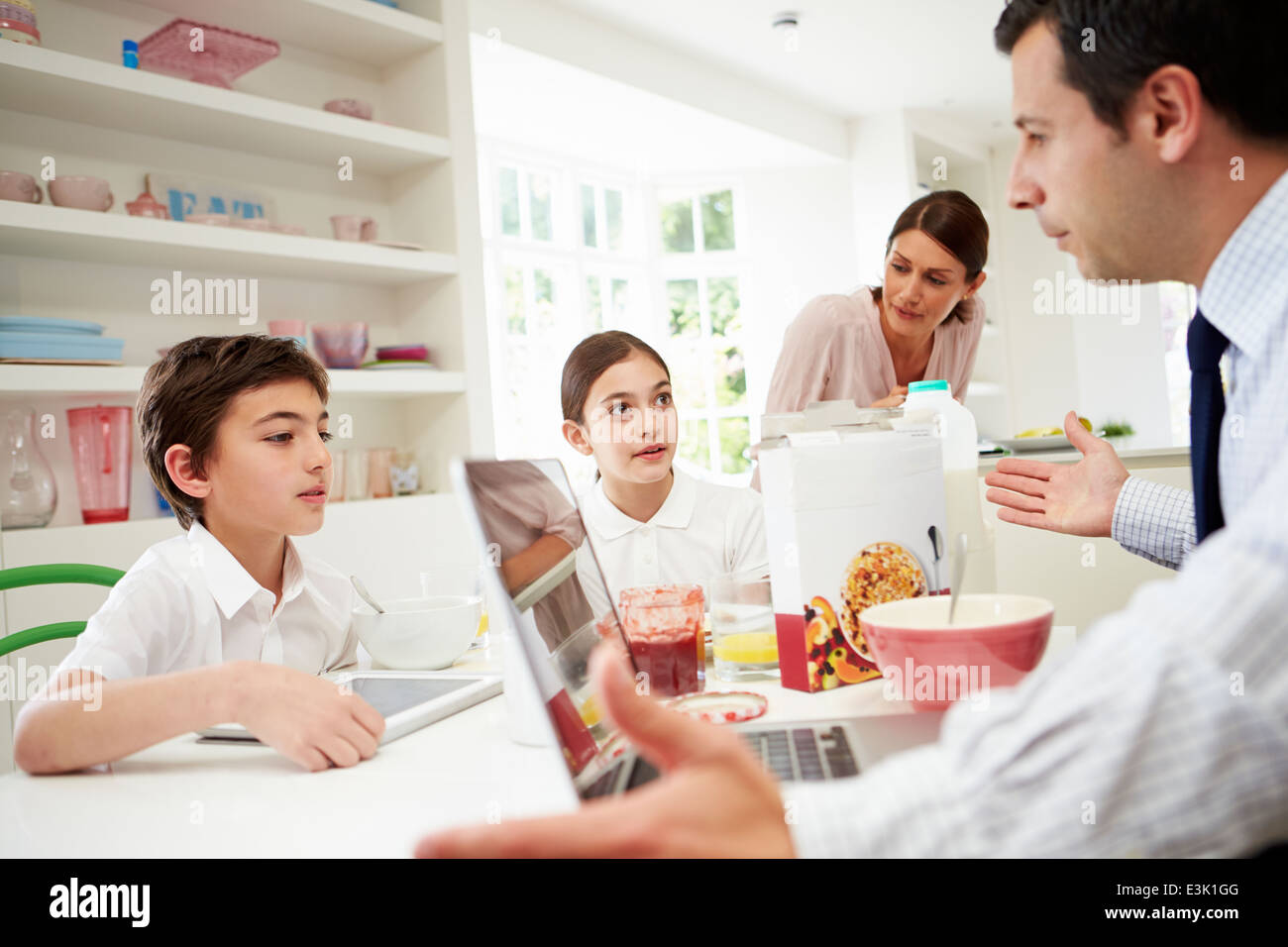 Family Using Digital Devices Having Argument Over Breakfast Stock Photo ...
