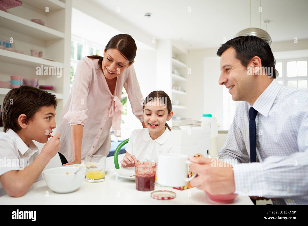 Family Having Breakfast Before Husband Goes To Work Stock Photo - Alamy