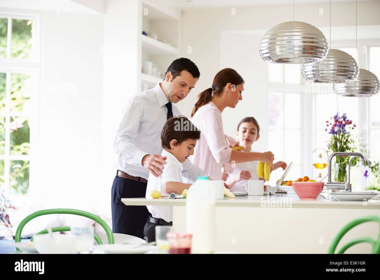Family Helping To Clear Up After Breakfast Stock Photo - Alamy