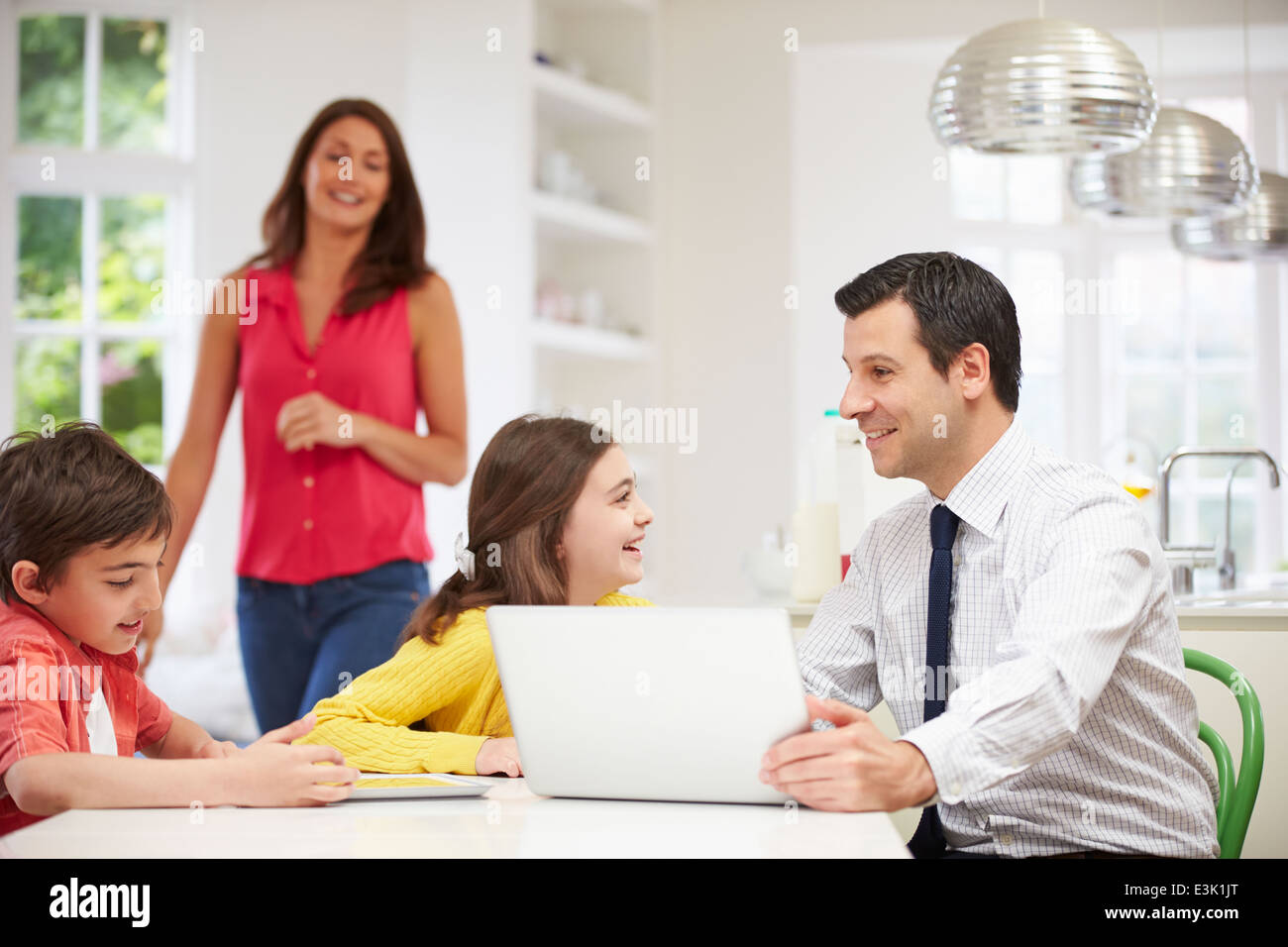 Family Using Digital Devices At Breakfast Table Stock Photo - Alamy