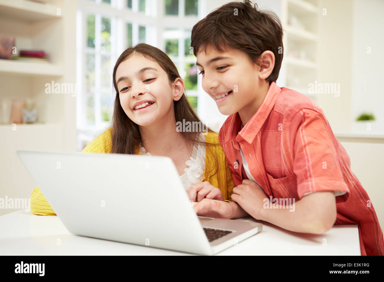 Two Hispanic Children Looking at Laptop Stock Photo - Alamy