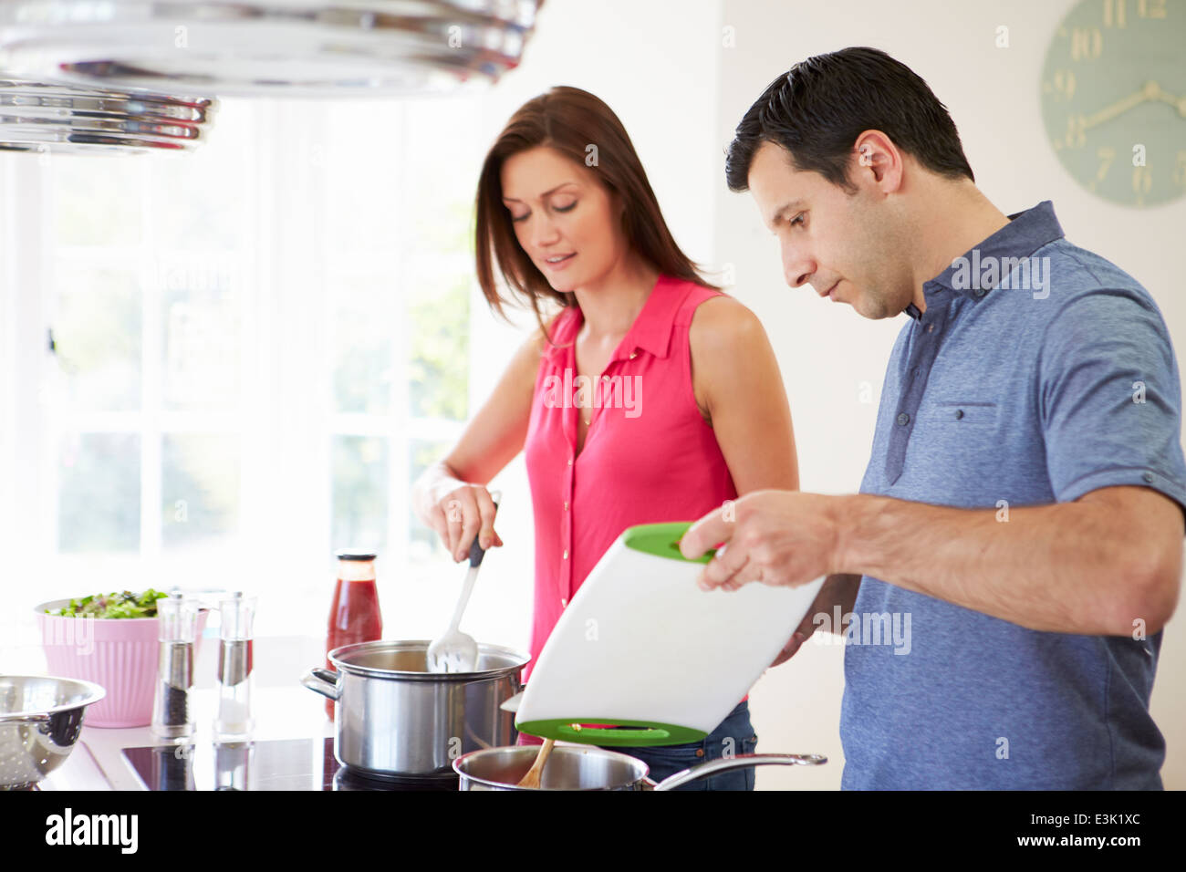 Hispanic Couple Cooking Meal At Home Together Stock Photo - Alamy