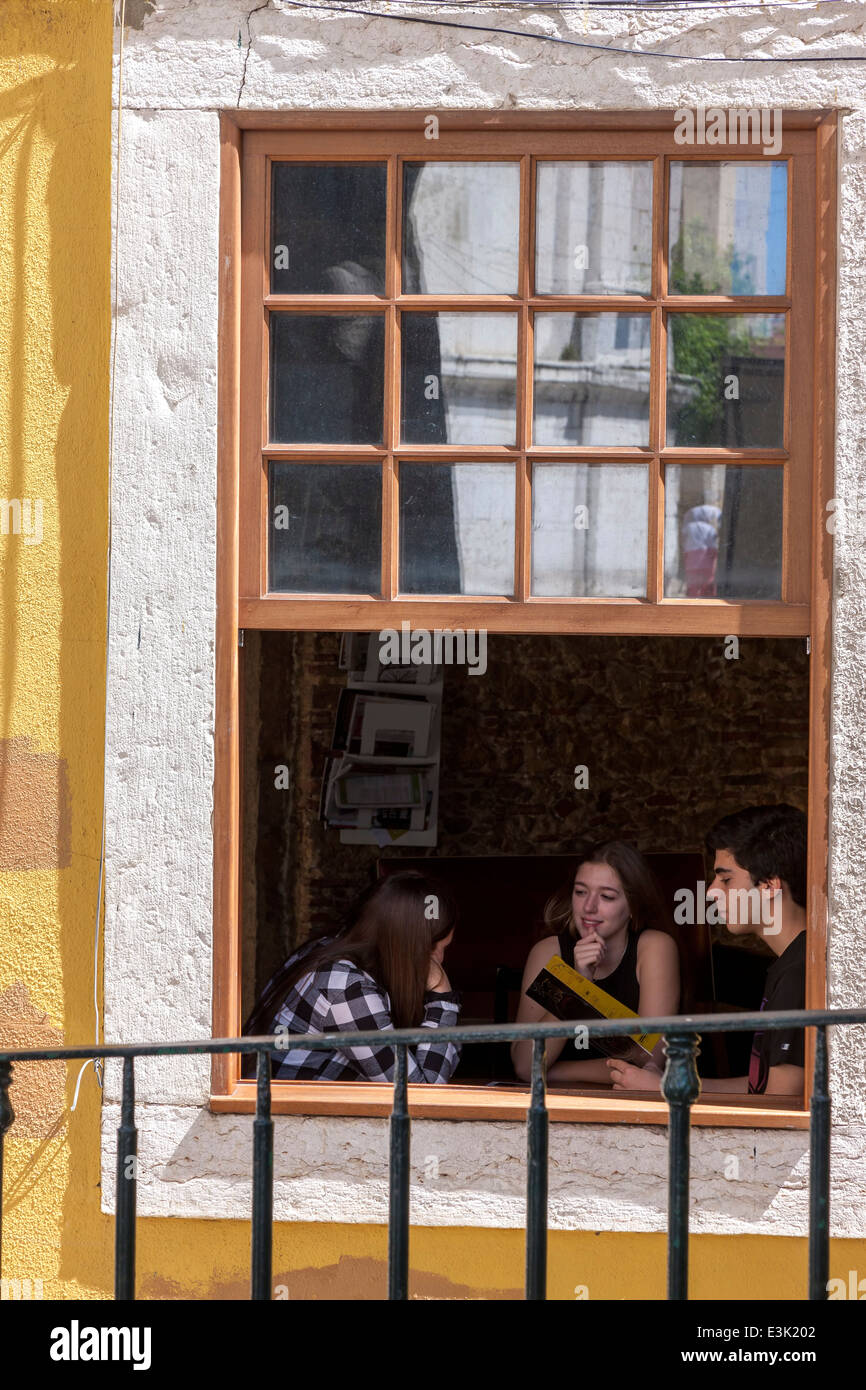 Looking in through a window with people sat looking a menu Stock Photo ...