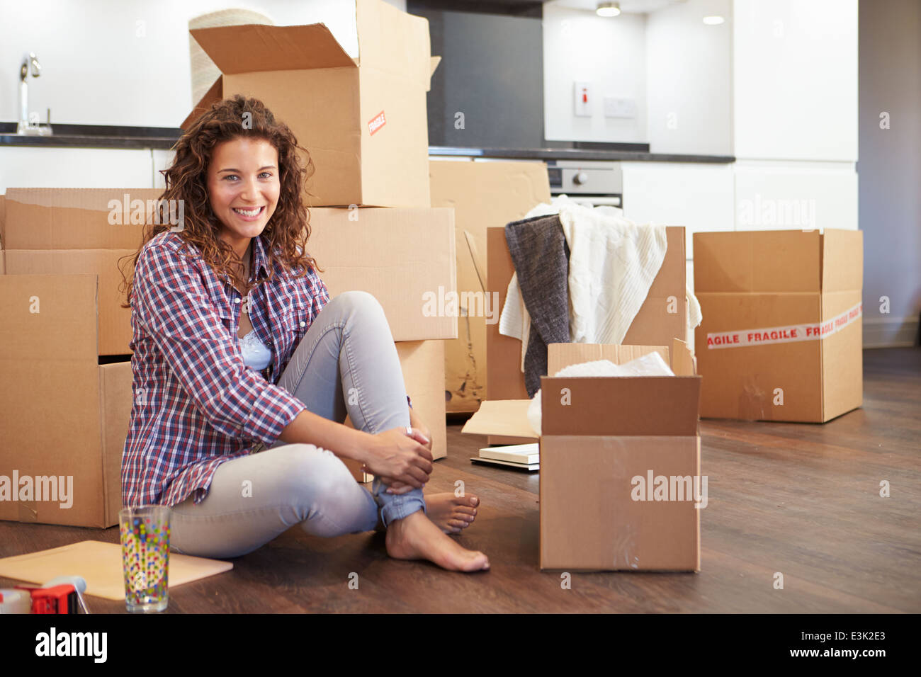 Woman Moving Into New Home And Unpacking Boxes Stock Photo - Alamy
