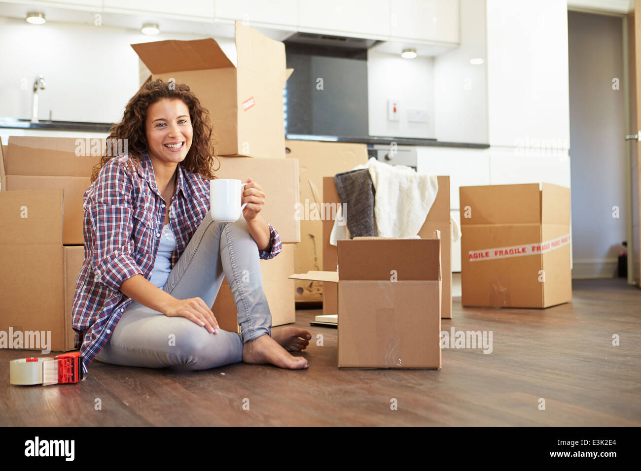 Woman Moving Into New Home And Unpacking Boxes Stock Photo - Alamy