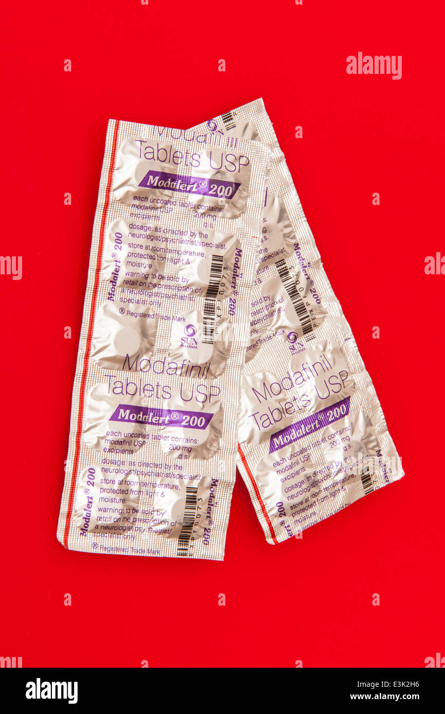 Modafinil, Modalet 200 tablets or pills on a bright red studio ...