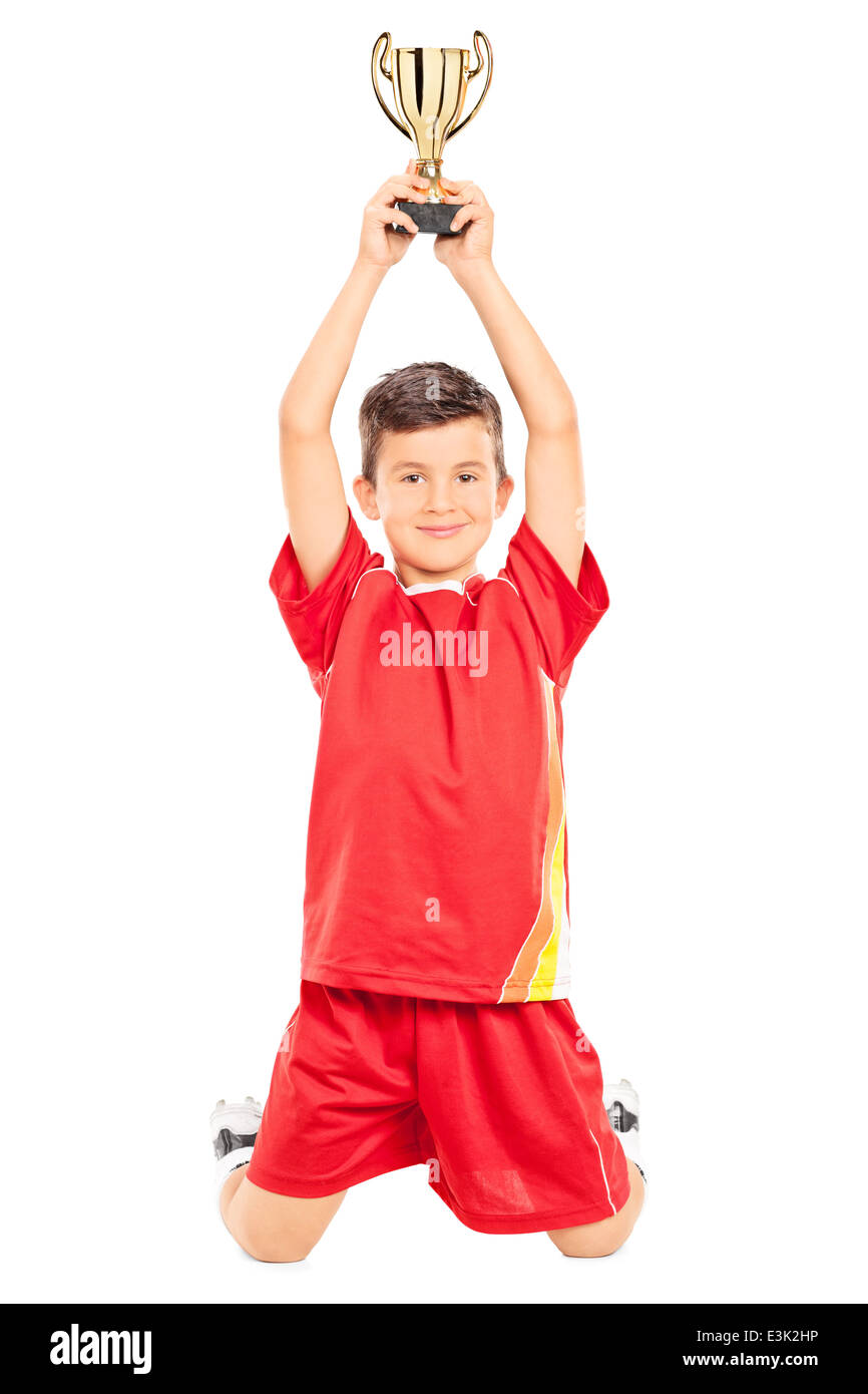 Joyful little boy holding a trophy above his head Stock Photo - Alamy