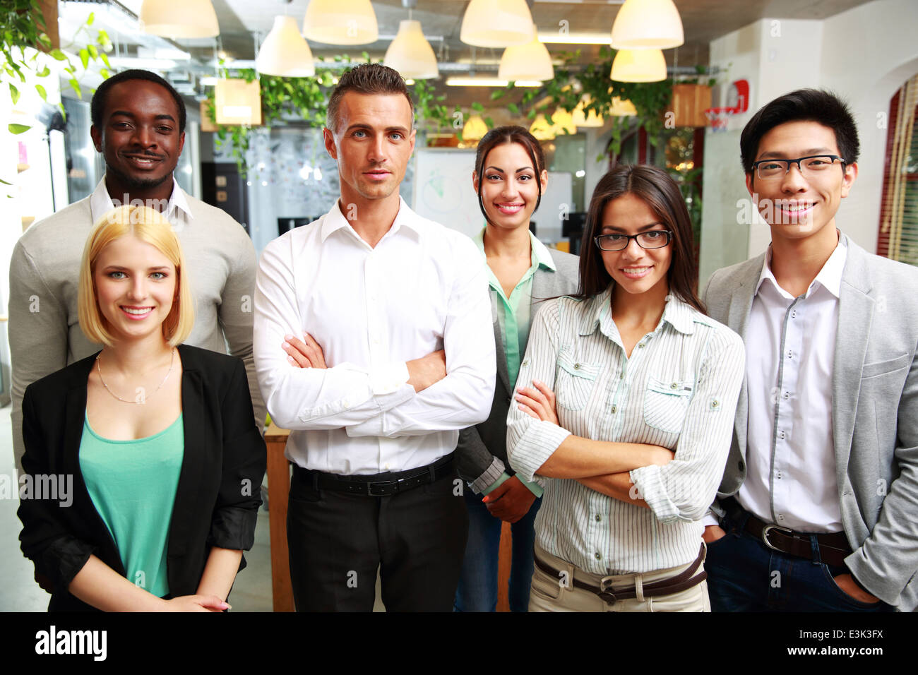 Group Of A Smiling Businesspeople Standing Together In Office Stock