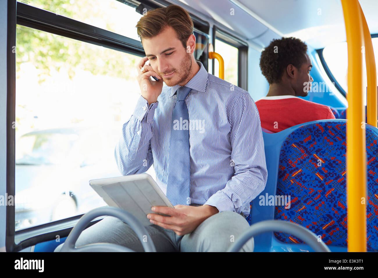 Businessman Using Mobile Phone And Digital Tablet On Bus Stock Photo ...