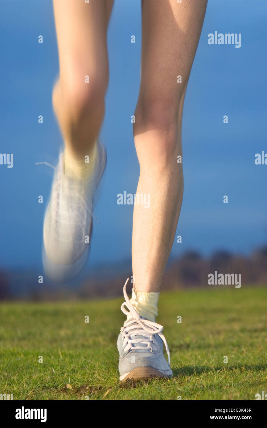 Woman´s legs running on grass Stock Photo - Alamy