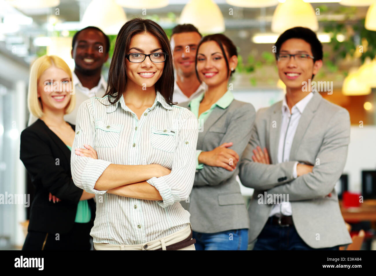 Smiling group of co-workers standing in office Stock Photo - Alamy