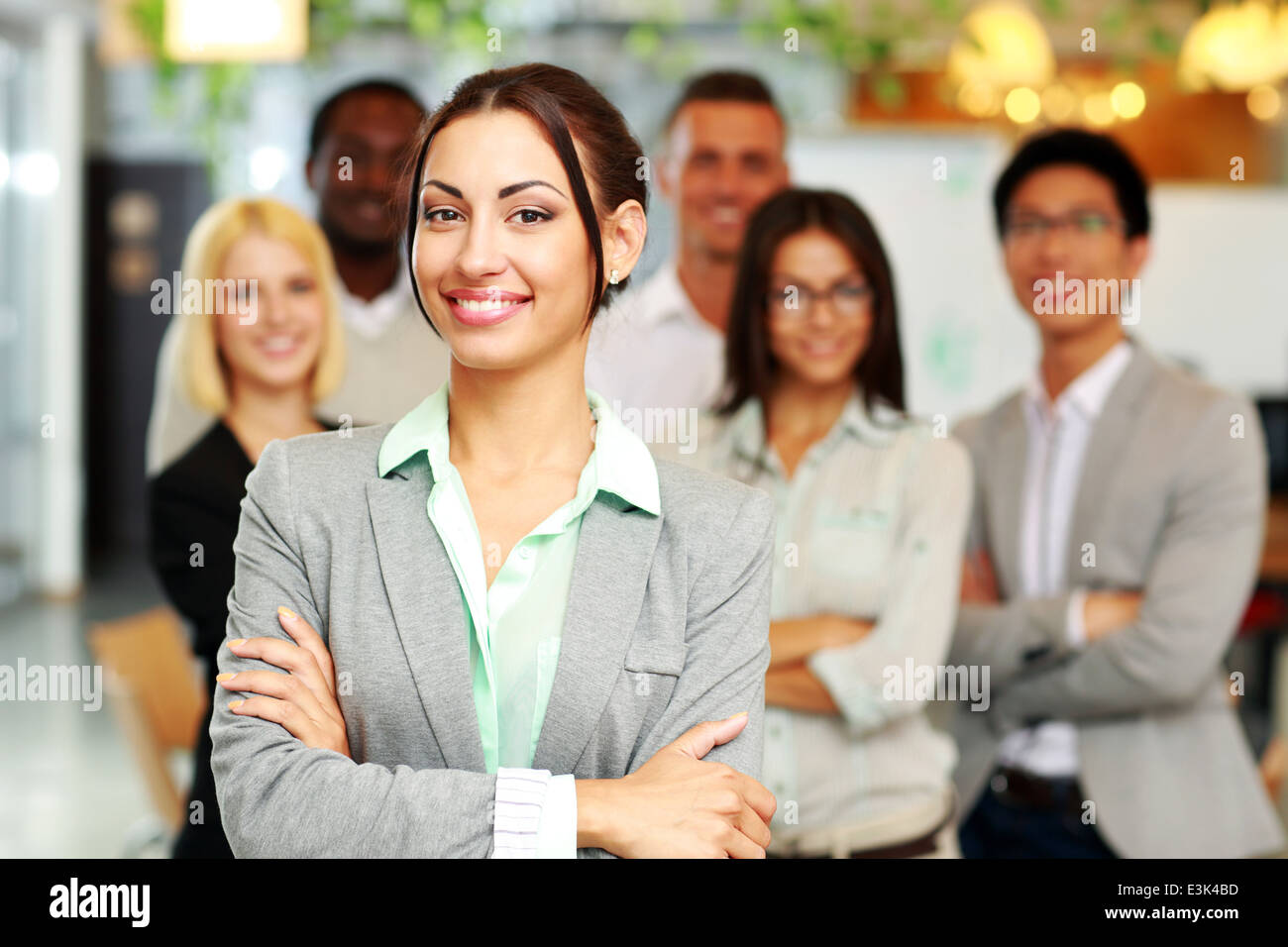 Cheerful group of co-workers standing in office Stock Photo - Alamy