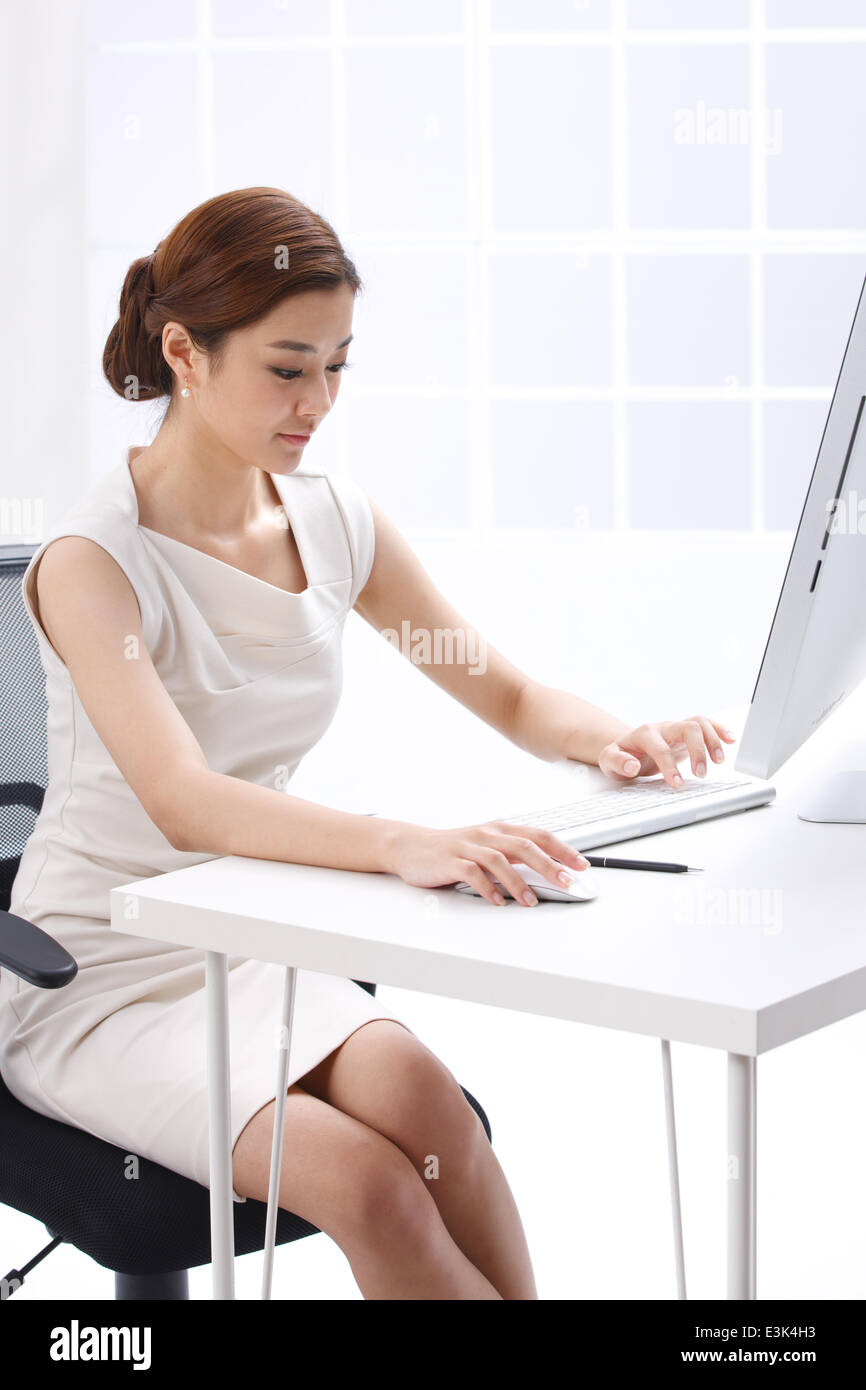 Young business lady using computer Stock Photo - Alamy