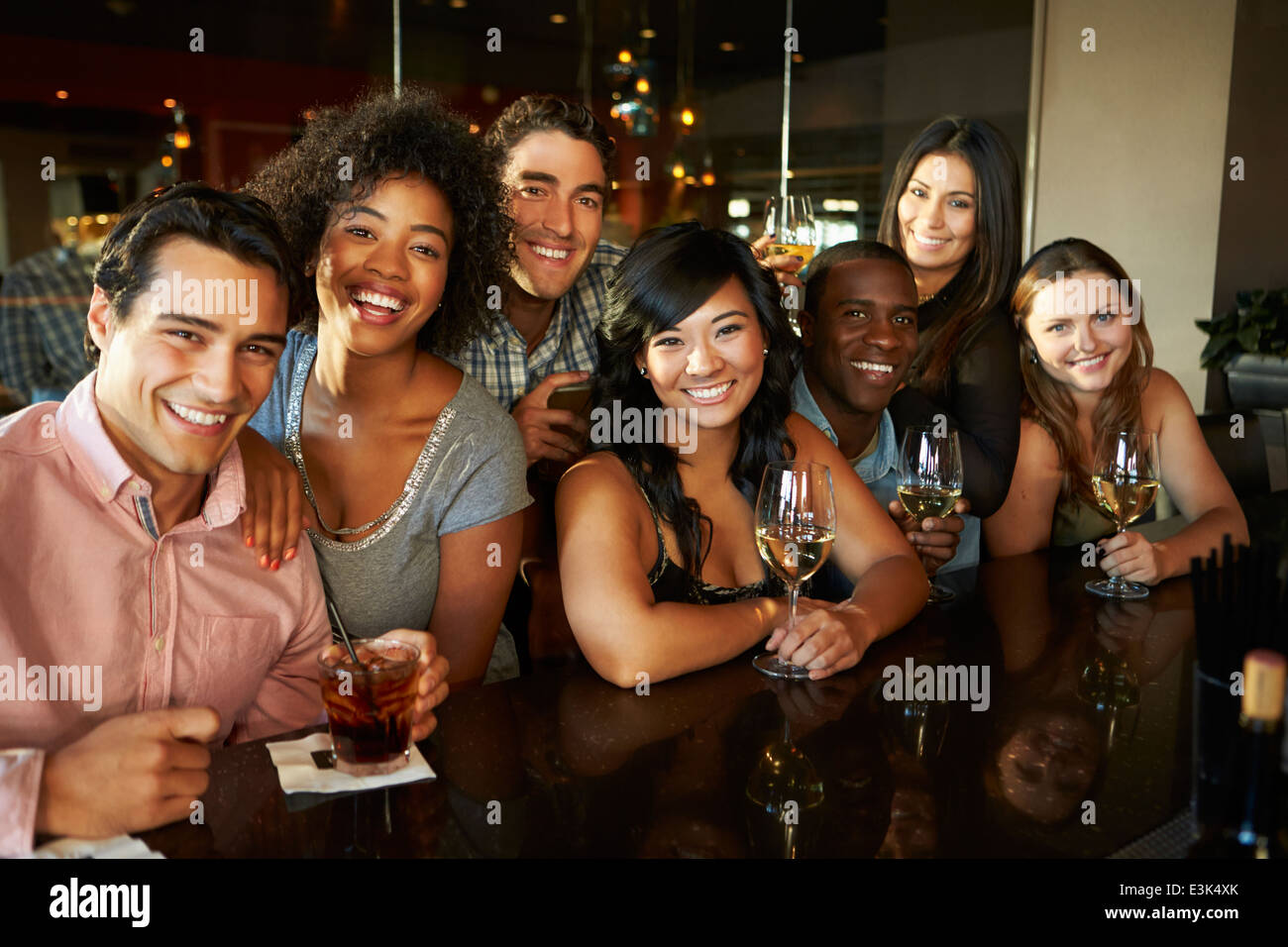 Group Of Friends Enjoying Drink At Bar Together Stock Photo - Alamy