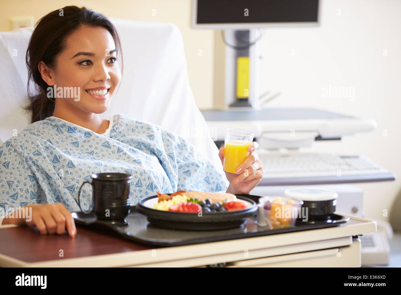 Female Patient Enjoying Meal In Hospital Bed Stock Photo - Alamy