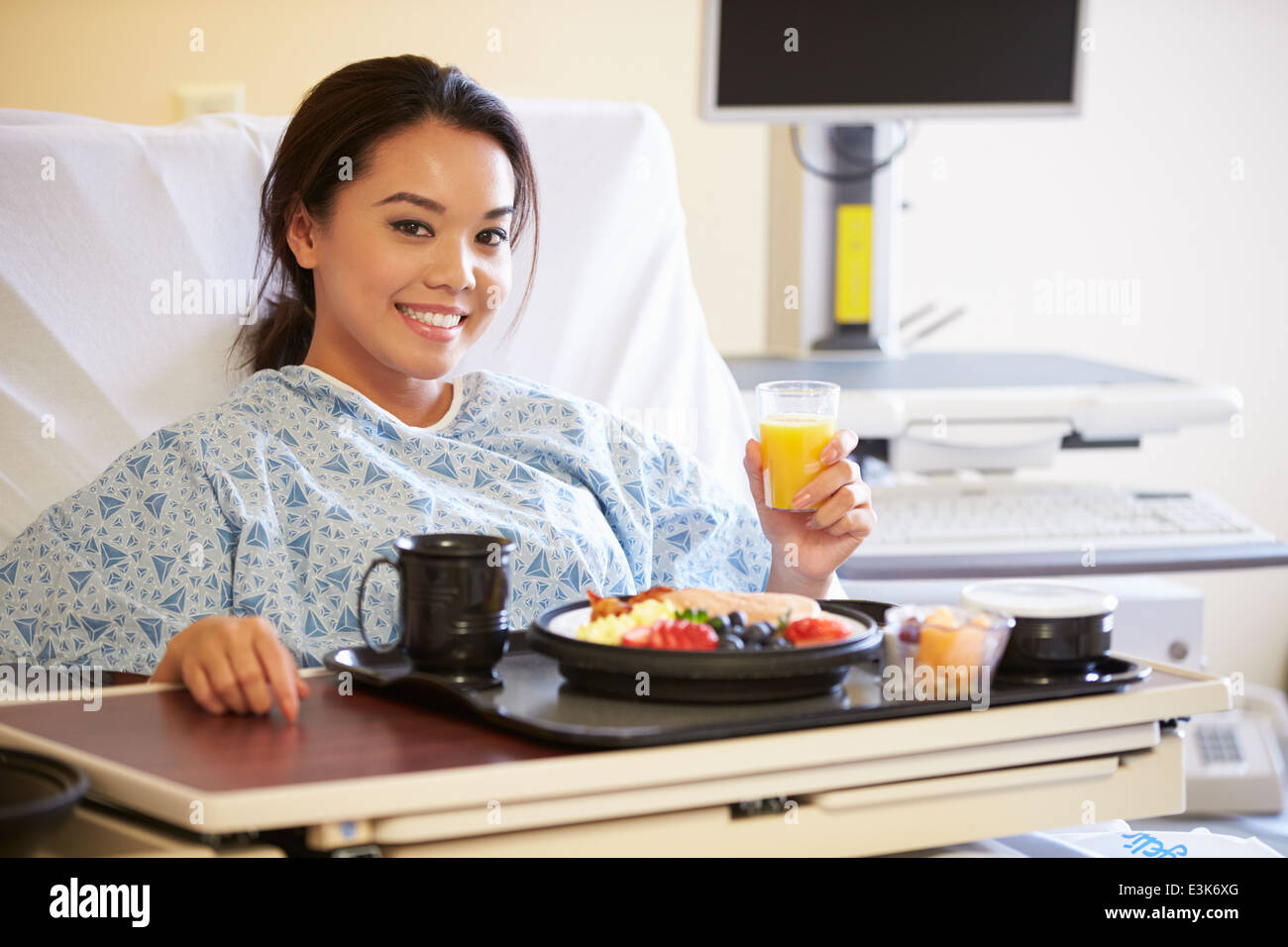 Female Patient Enjoying Meal In Hospital Bed Stock Photo - Alamy