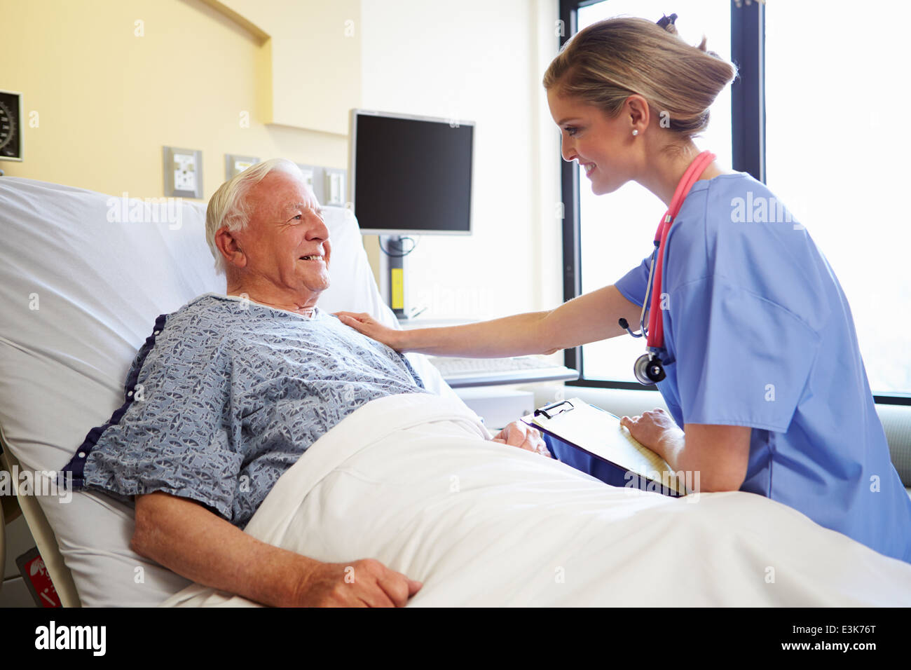 Nurse Talking To Senior Male Patient In Hospital Room Stock Photo - Alamy