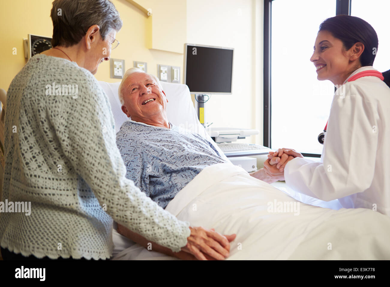 Female Doctor Talking To Senior Couple In Hospital Room Stock Photo - Alamy