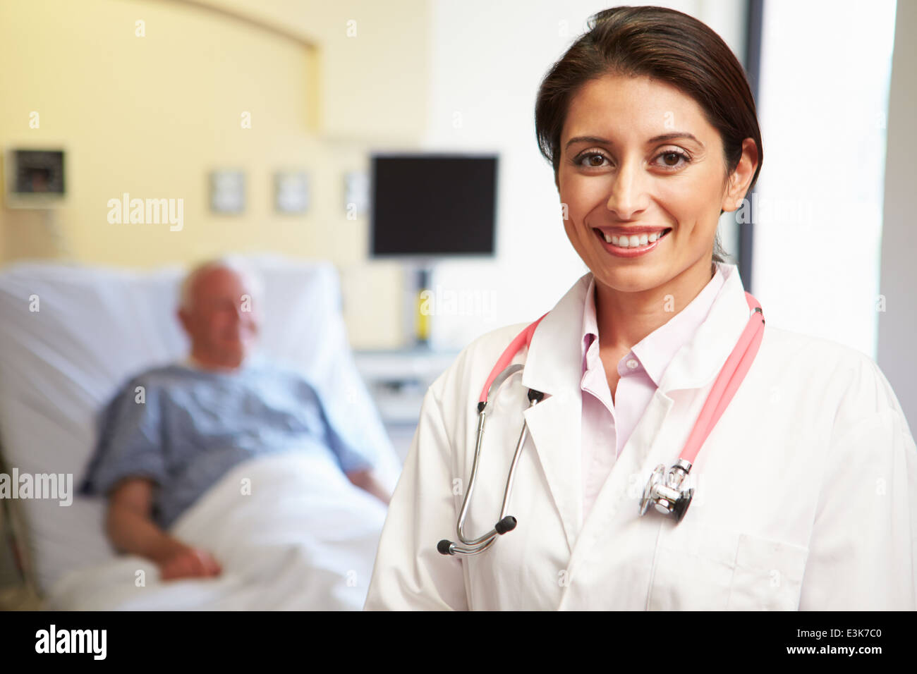Portrait Of Female Doctor With Patient In Background Stock Photo - Alamy