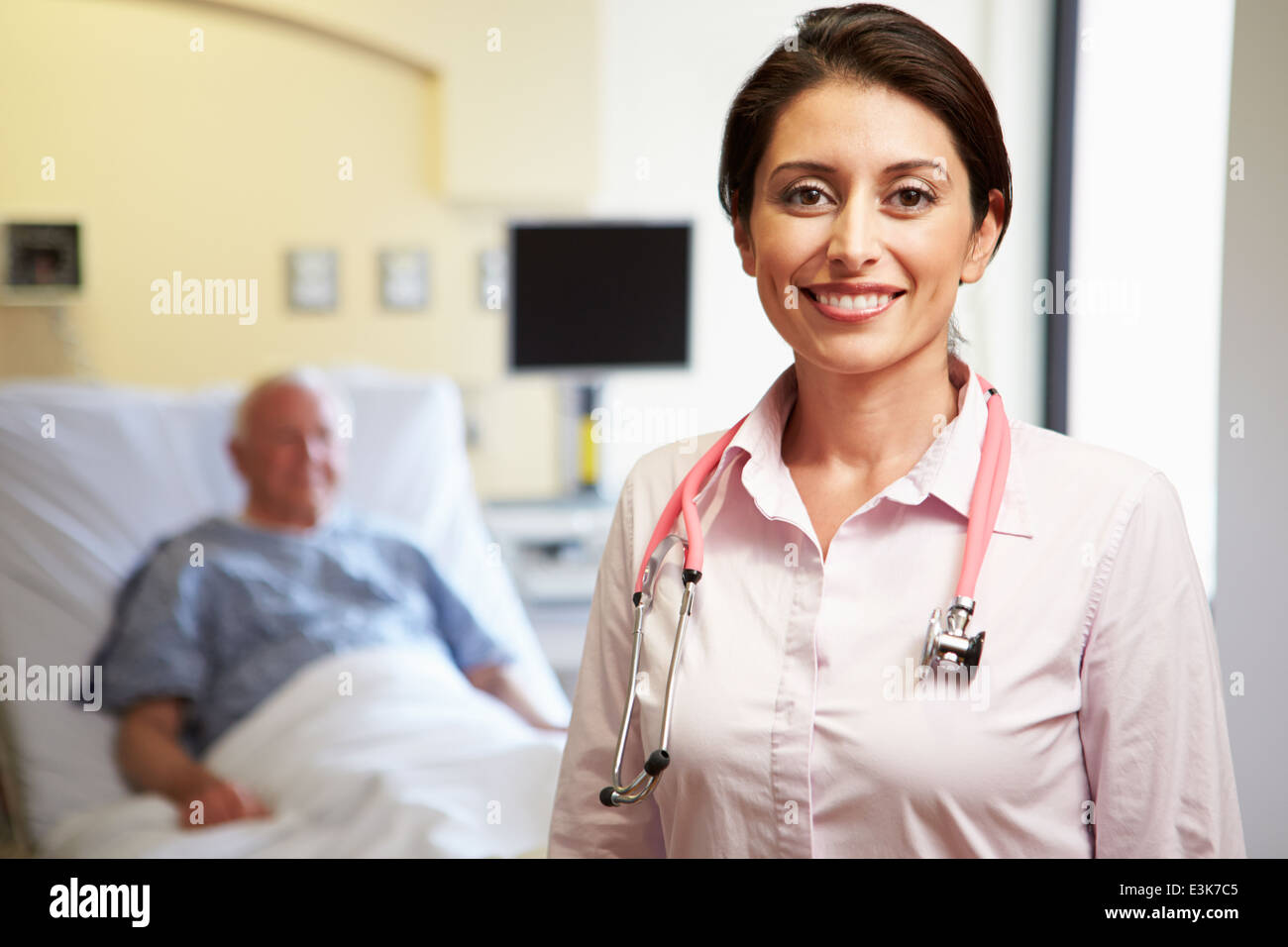 Portrait Of Female Doctor With Patient In Background Stock Photo - Alamy