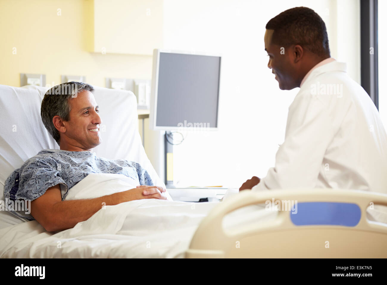 Doctor Talking To Male Patient In Hospital Room Stock Photo - Alamy