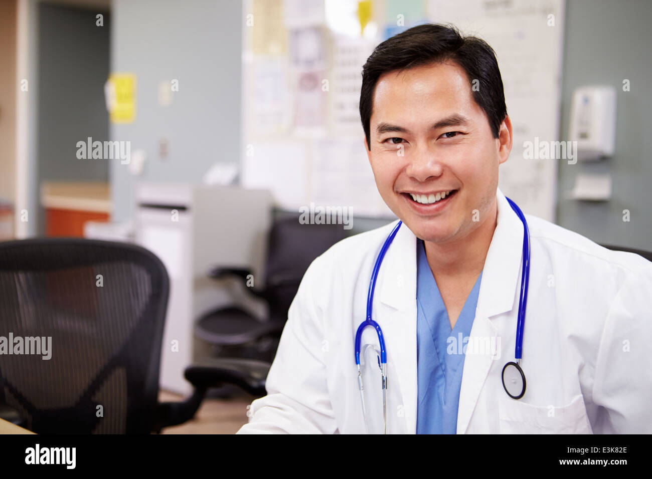 Portrait Of Doctor Working At Nurses Station Stock Photo - Alamy